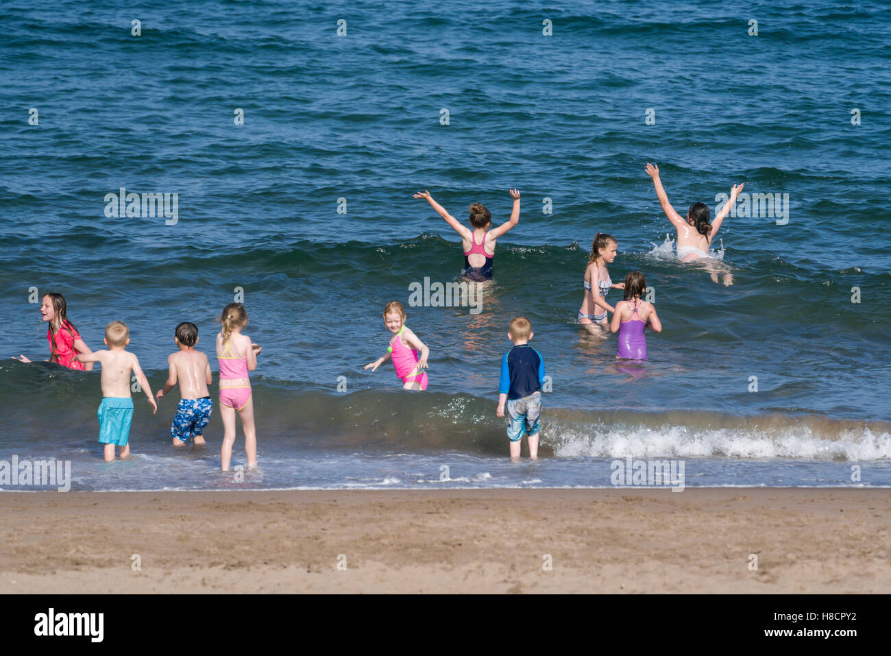 Kids play in the waves, Spittal Beach, Northumberland Stock Photo - Alamy