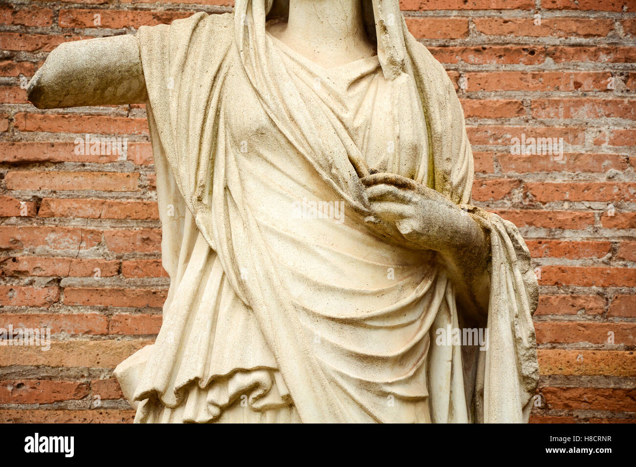 A roman statue torso against an old brick wall Stock Photo - Alamy