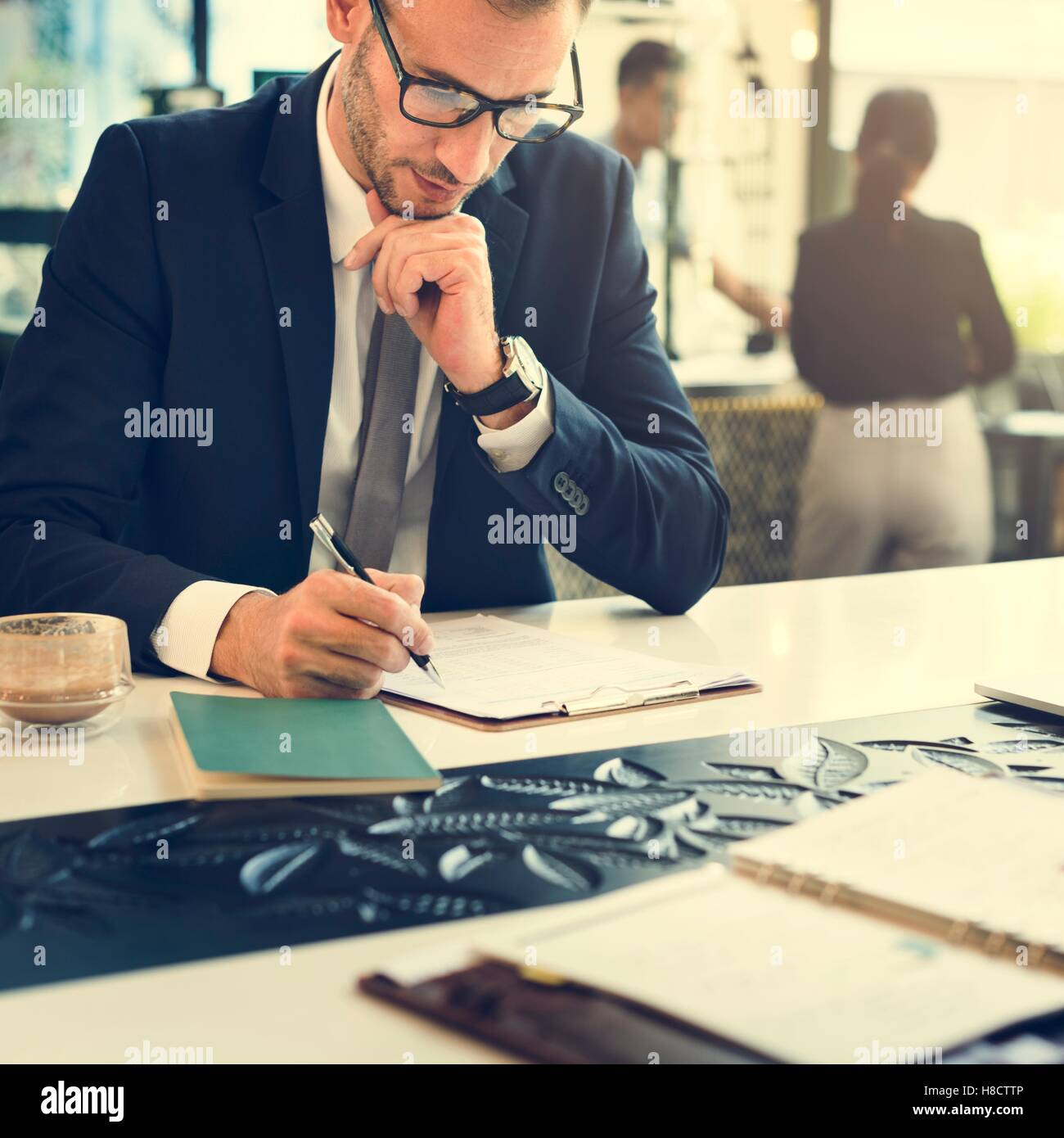 Serious Business Man Filling Out Form Concept Stock Photo - Alamy