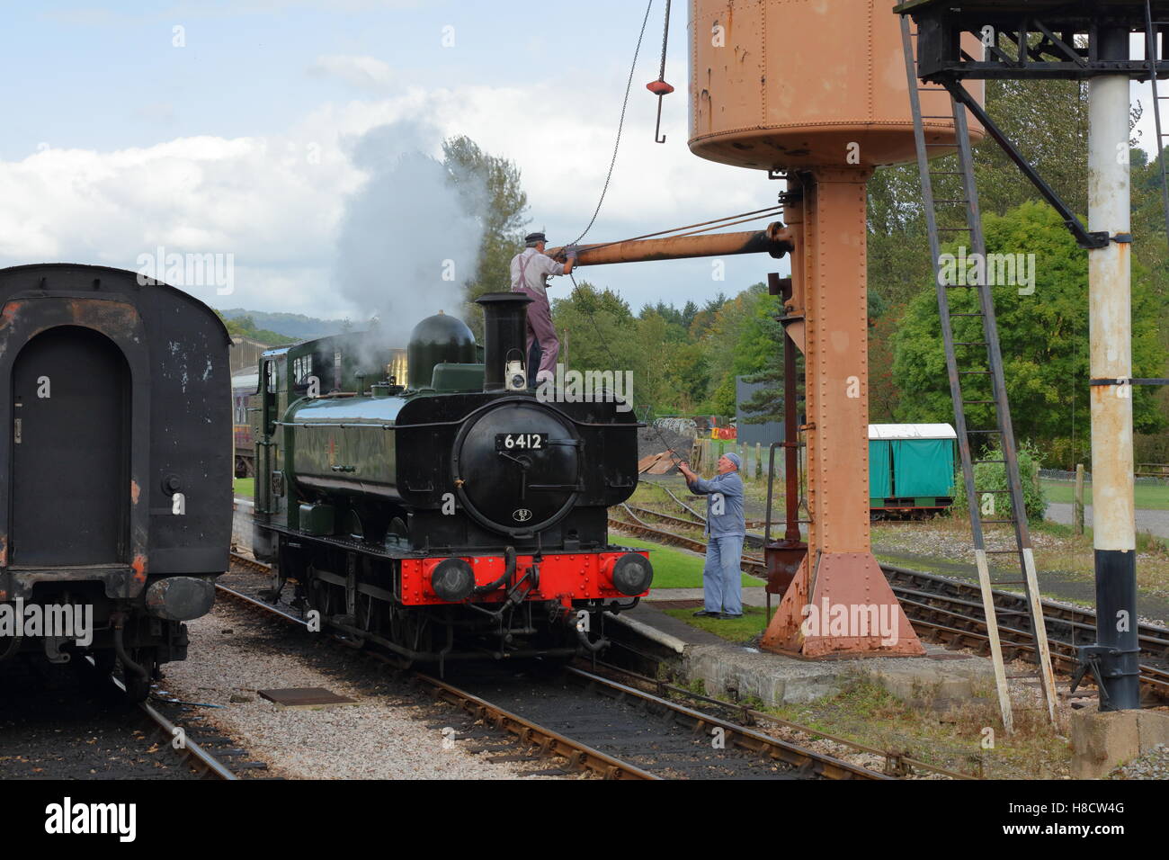 GWR Pannier Tanker 6412 topping up water at Buckfastleigh railway ...
