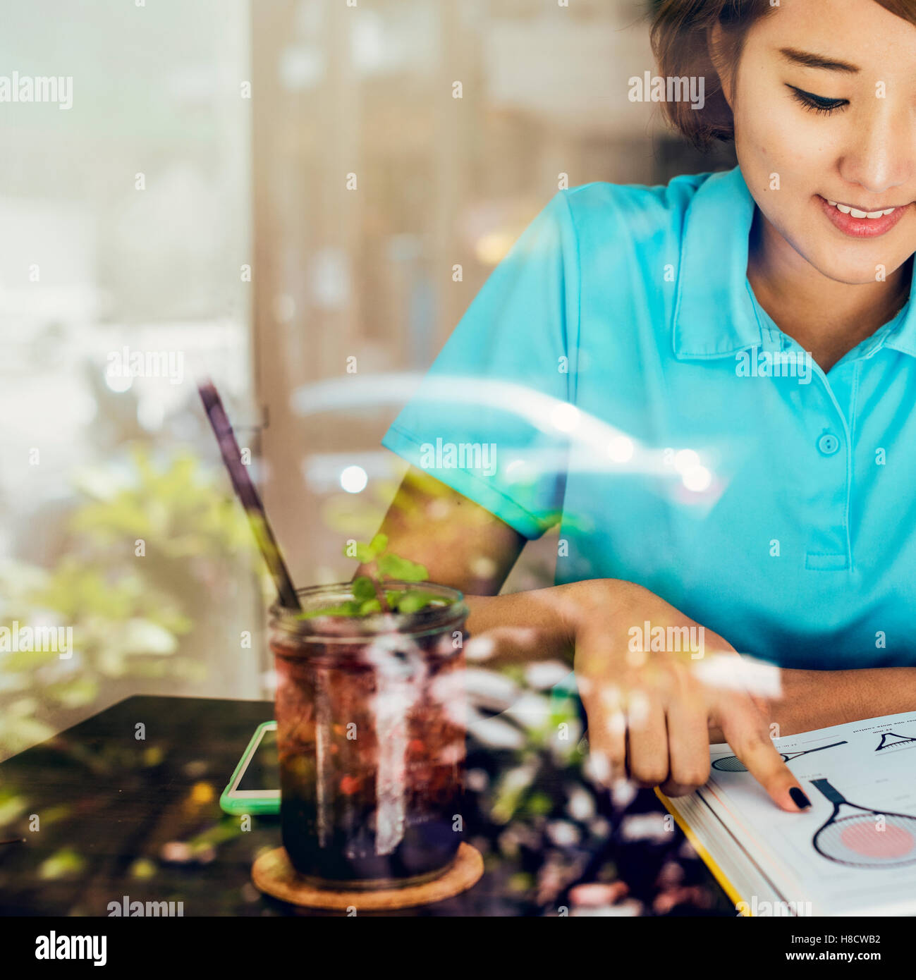 Asian Woman Reading Tennis Skills Book Concept Stock Photo - Alamy