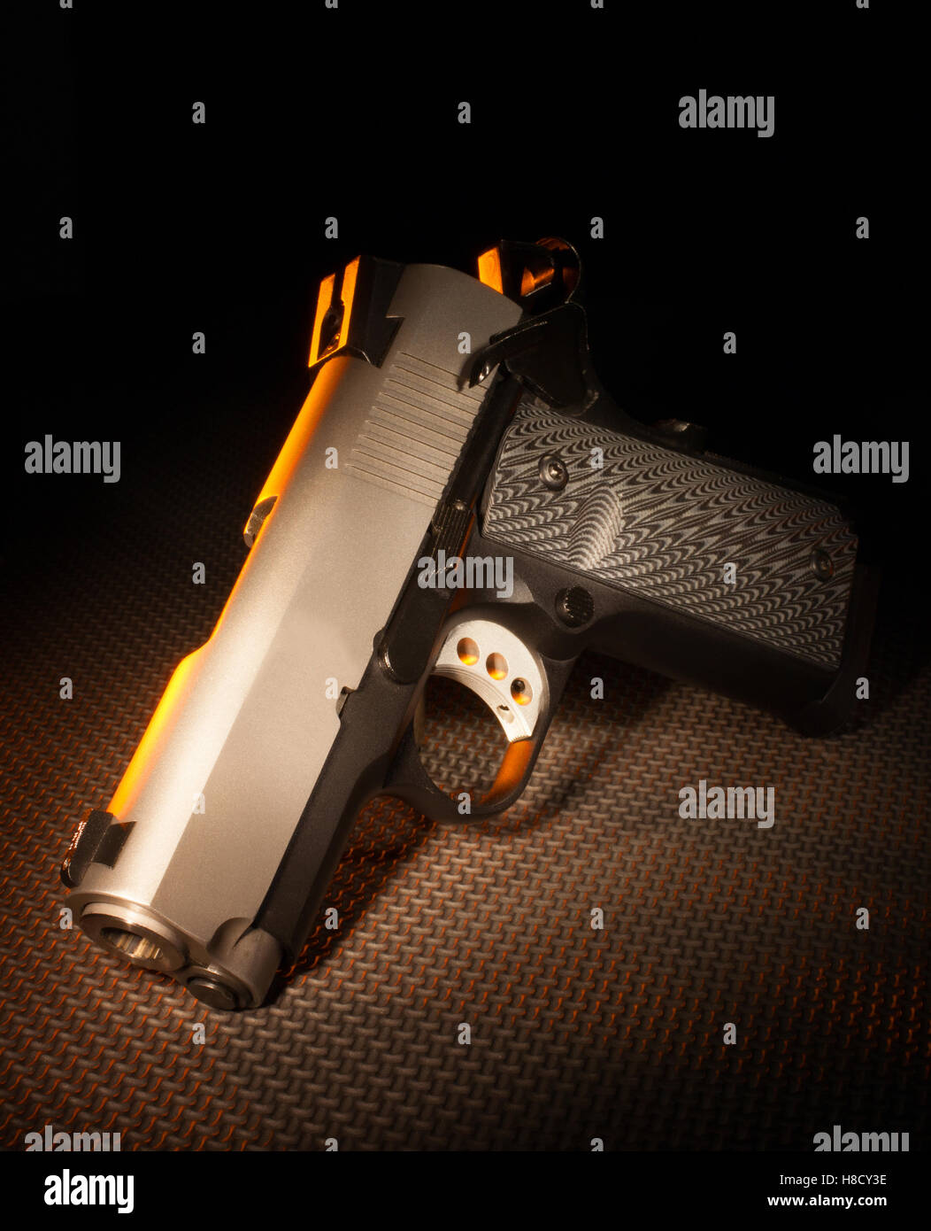 Semi automatic stainless steel handgun with yellow highlights Stock ...