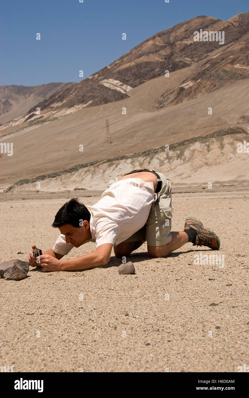 Young man taking pictures in the Atacama Desert, Chile, South America ...