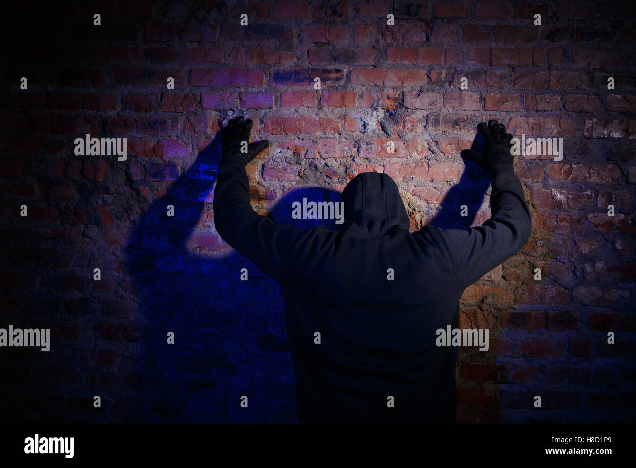 Gunman against wall at night Stock Photo - Alamy