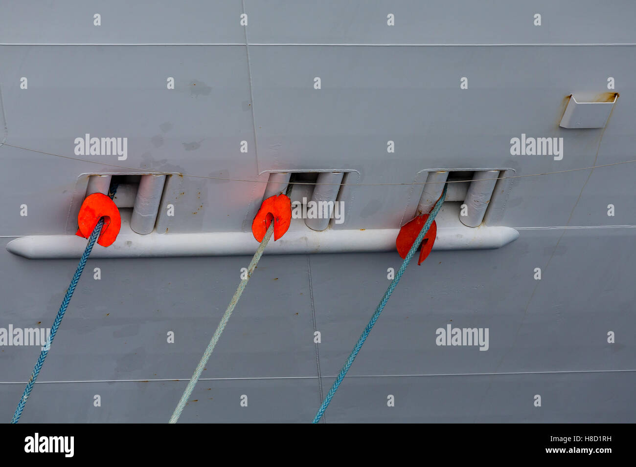 Three Ropes into Ships Hull from Pier Stock Photo - Alamy