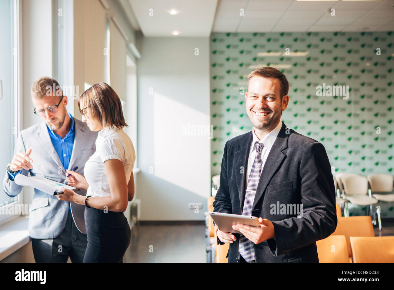 Three business people working in the office Stock Photo - Alamy