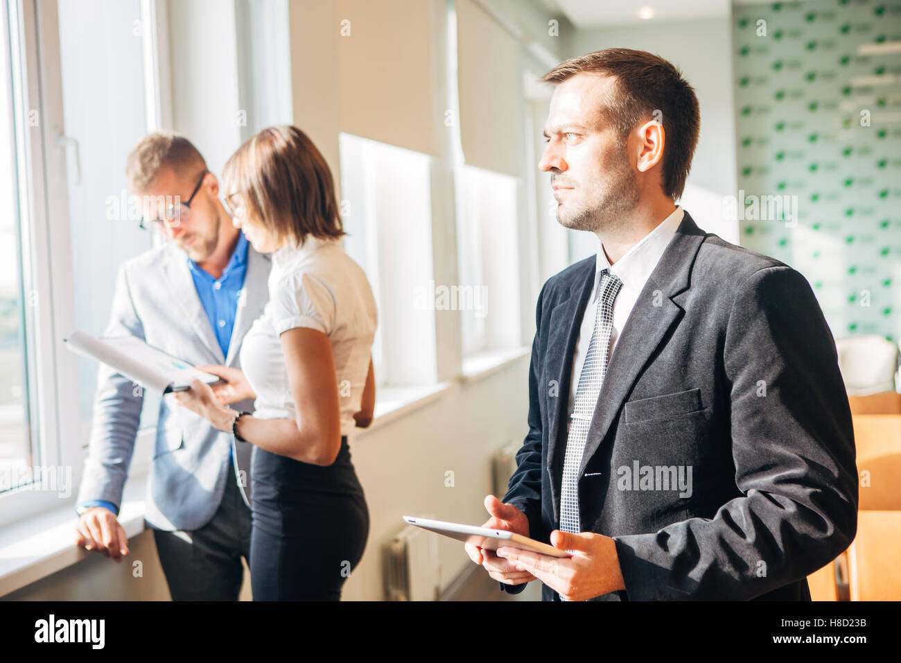 Three business people working in the office Stock Photo - Alamy