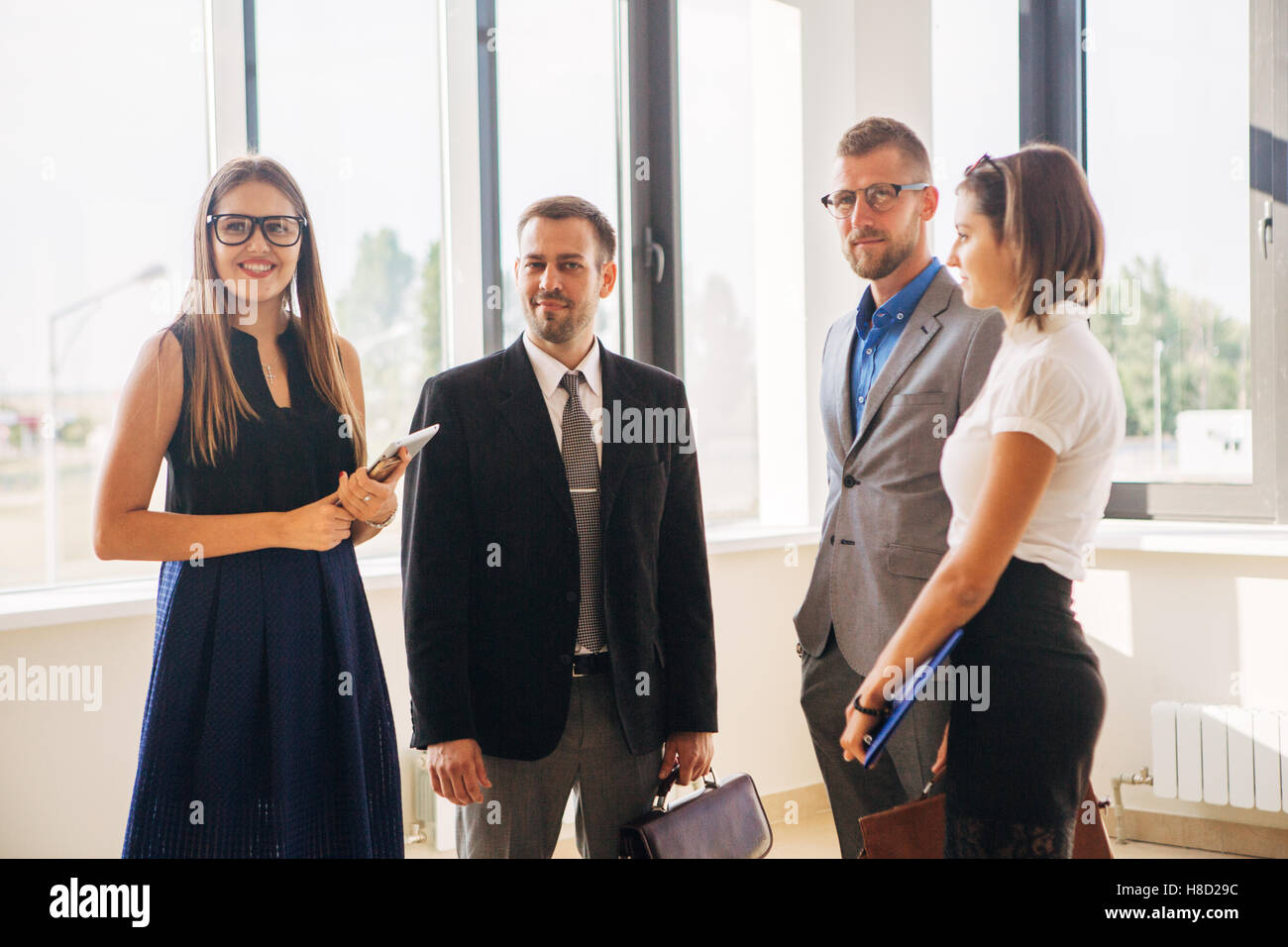 four business people handshake in office lobby Stock Photo - Alamy