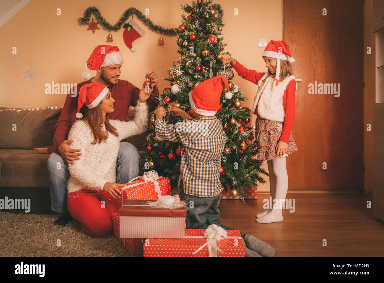 Family Decorating Christmas Tree Stock Photo - Alamy