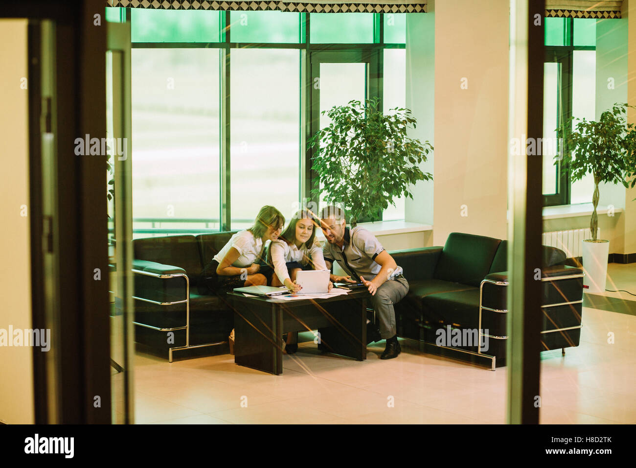 three colleagues discussing future business plan work Stock Photo - Alamy