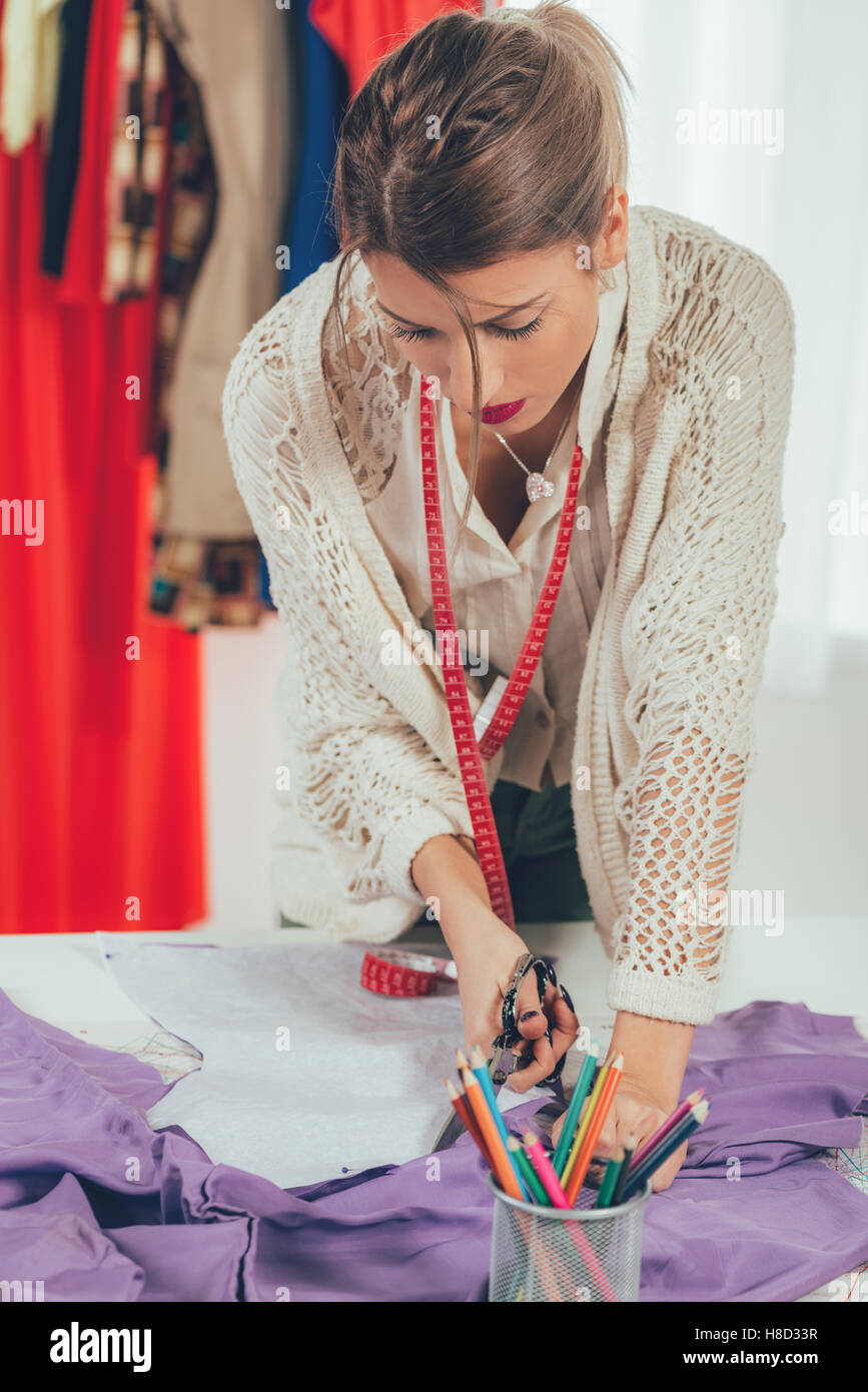 Female Tailor Cutting Material Stock Photo - Alamy