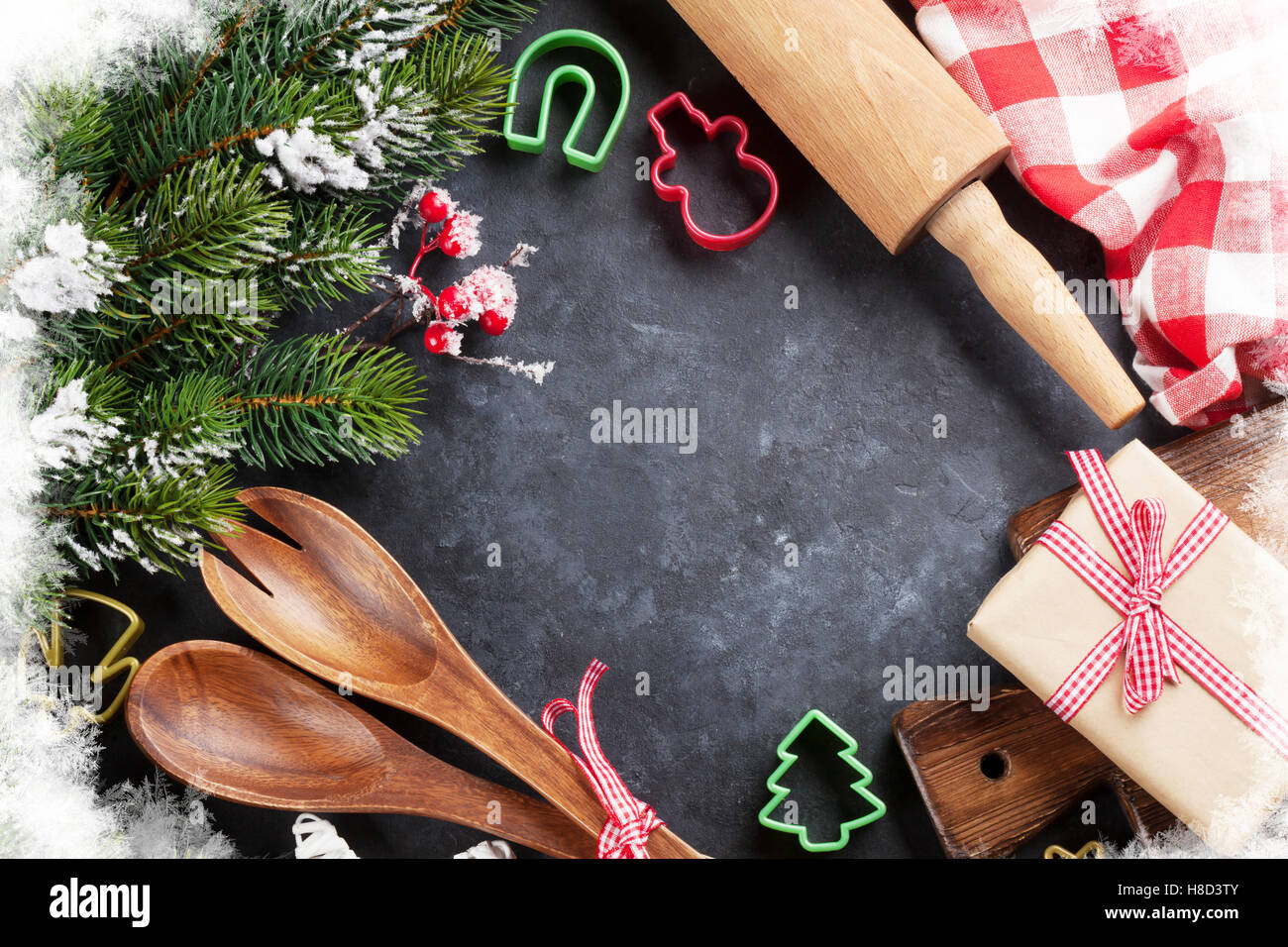 Christmas cooking utensils and snow tree on stone table. Top view with ...