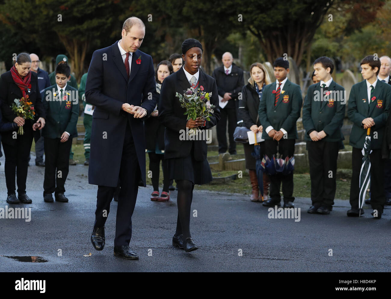 The Duke of Cambridge walks with Michaela McKay, 14, from St Michael's Youth Project, to lay a ...