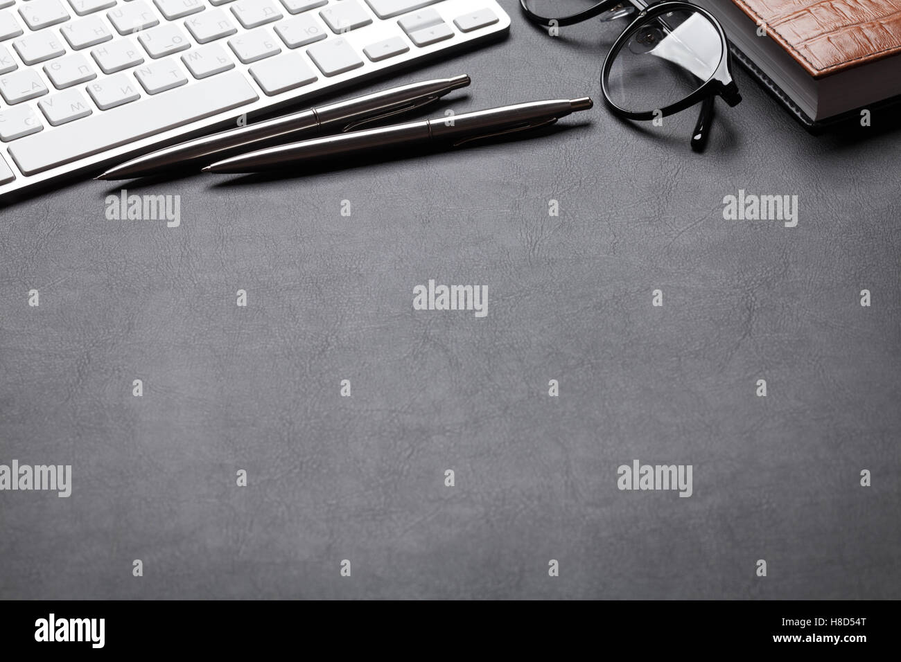 Office leather desk table with pc, notepad, pencil and pen. View with ...