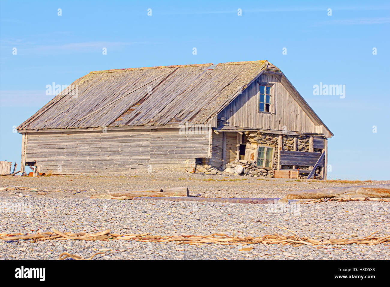 wooden hunting Lodge in open tundra, partially destroyed by hurricane ...