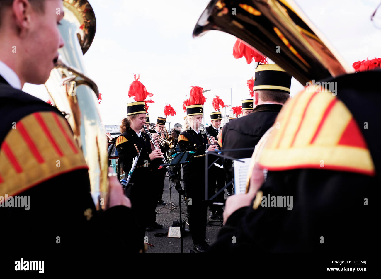 German brass band playing on Brighton seafront with red plumes on their ...
