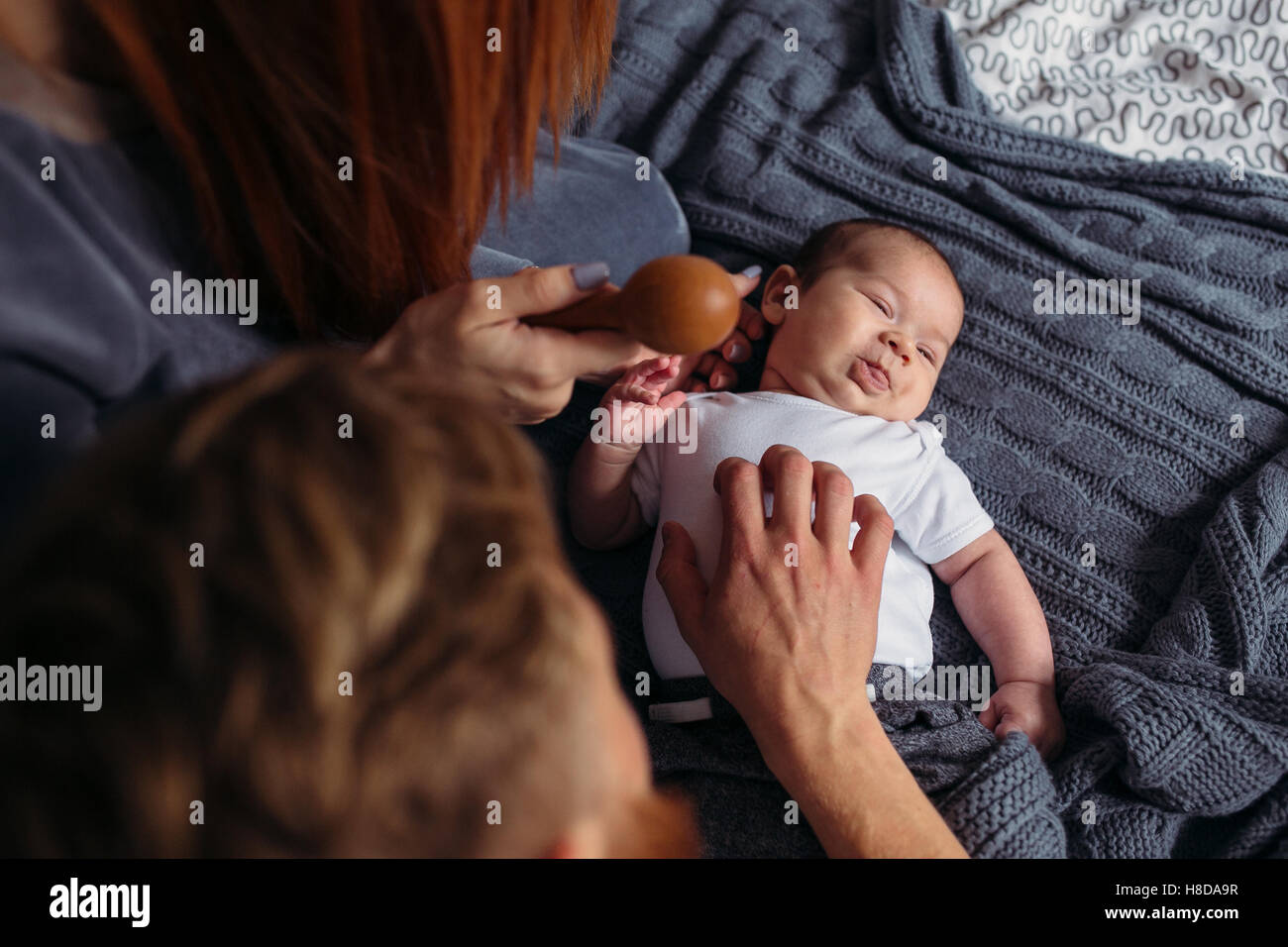 Young parents giving of attention to their baby Stock Photo - Alamy
