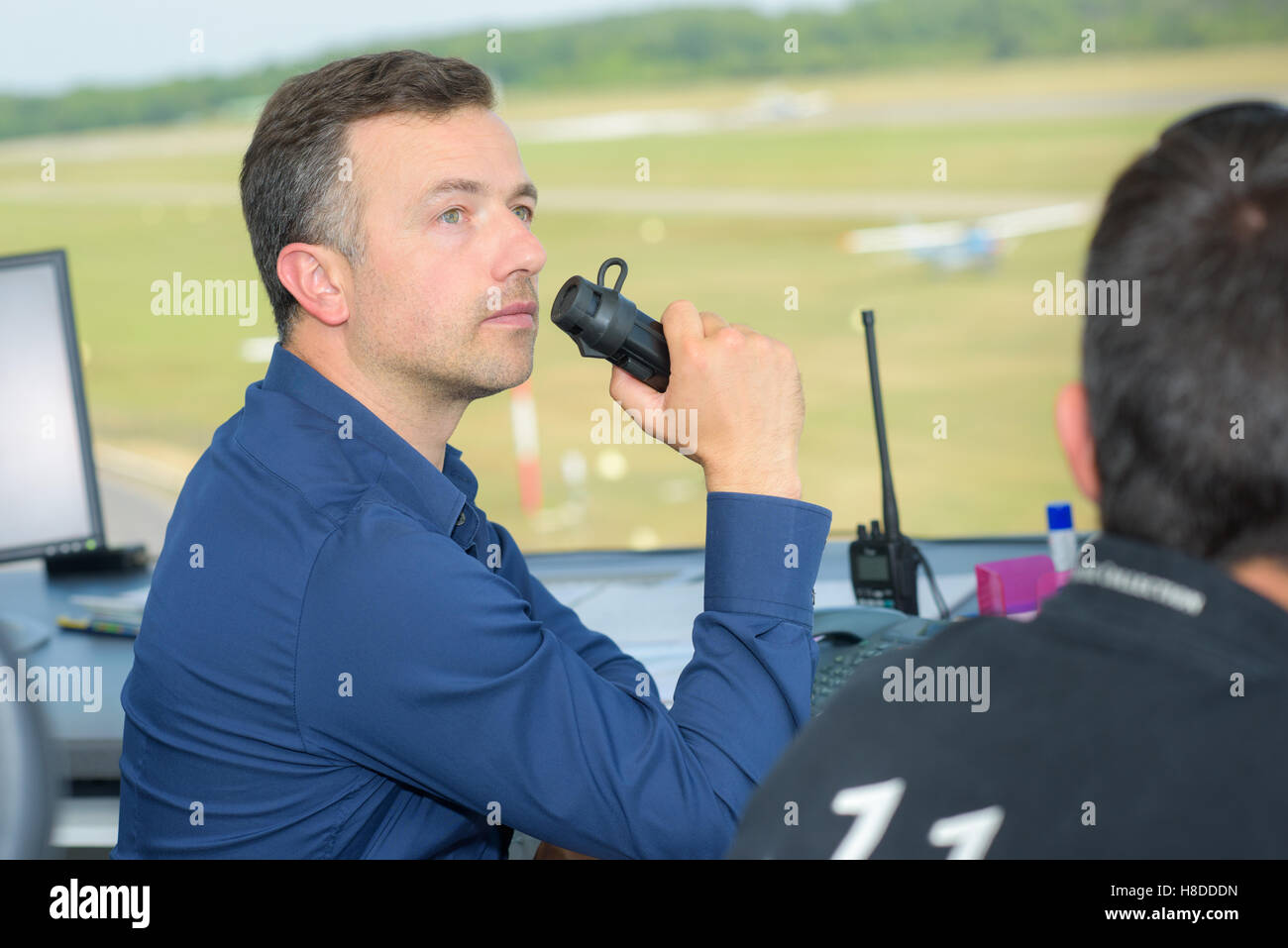 Closeup of male control tower worker Stock Photo - Alamy