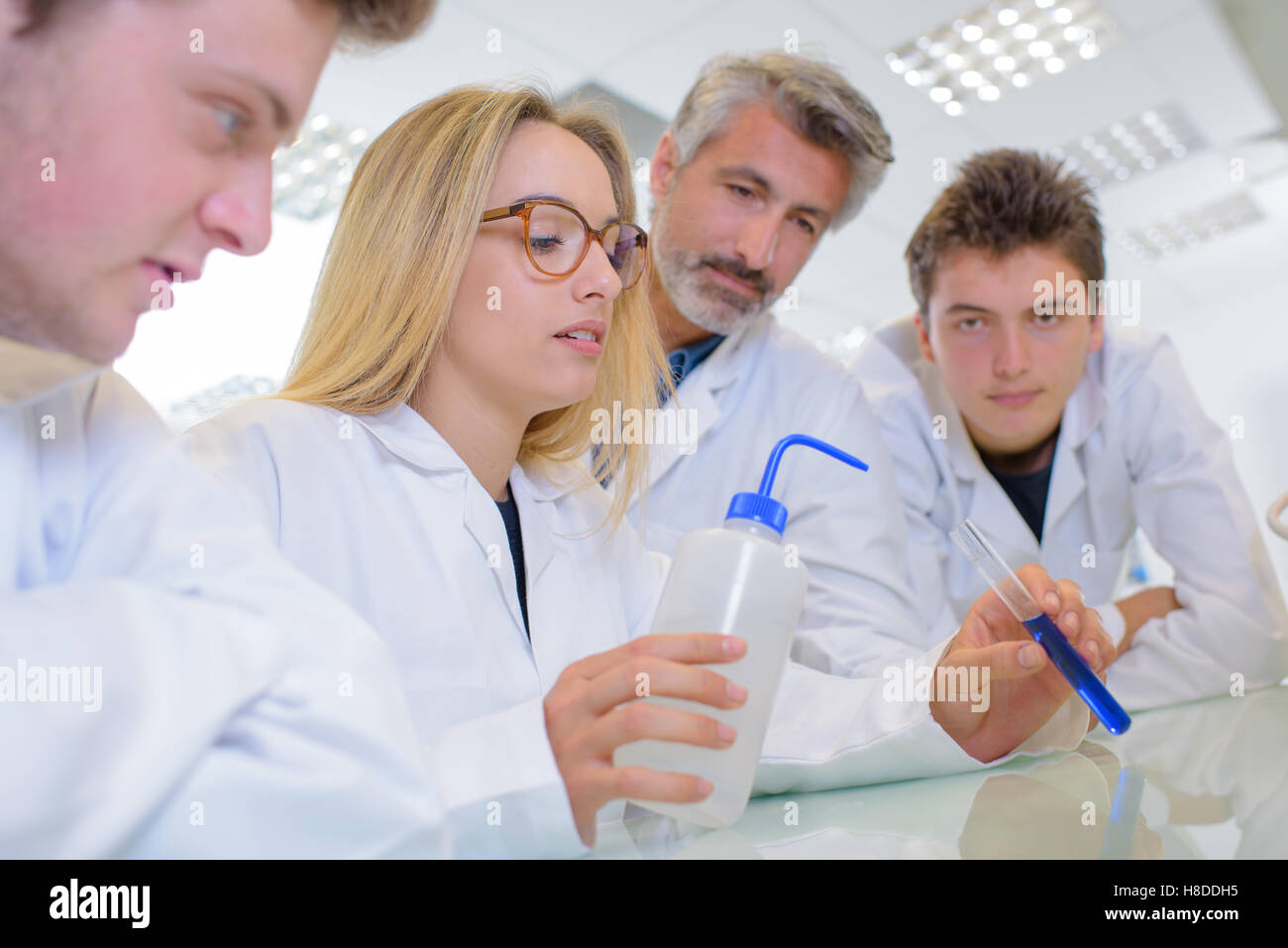 young woman showing an experiment Stock Photo - Alamy