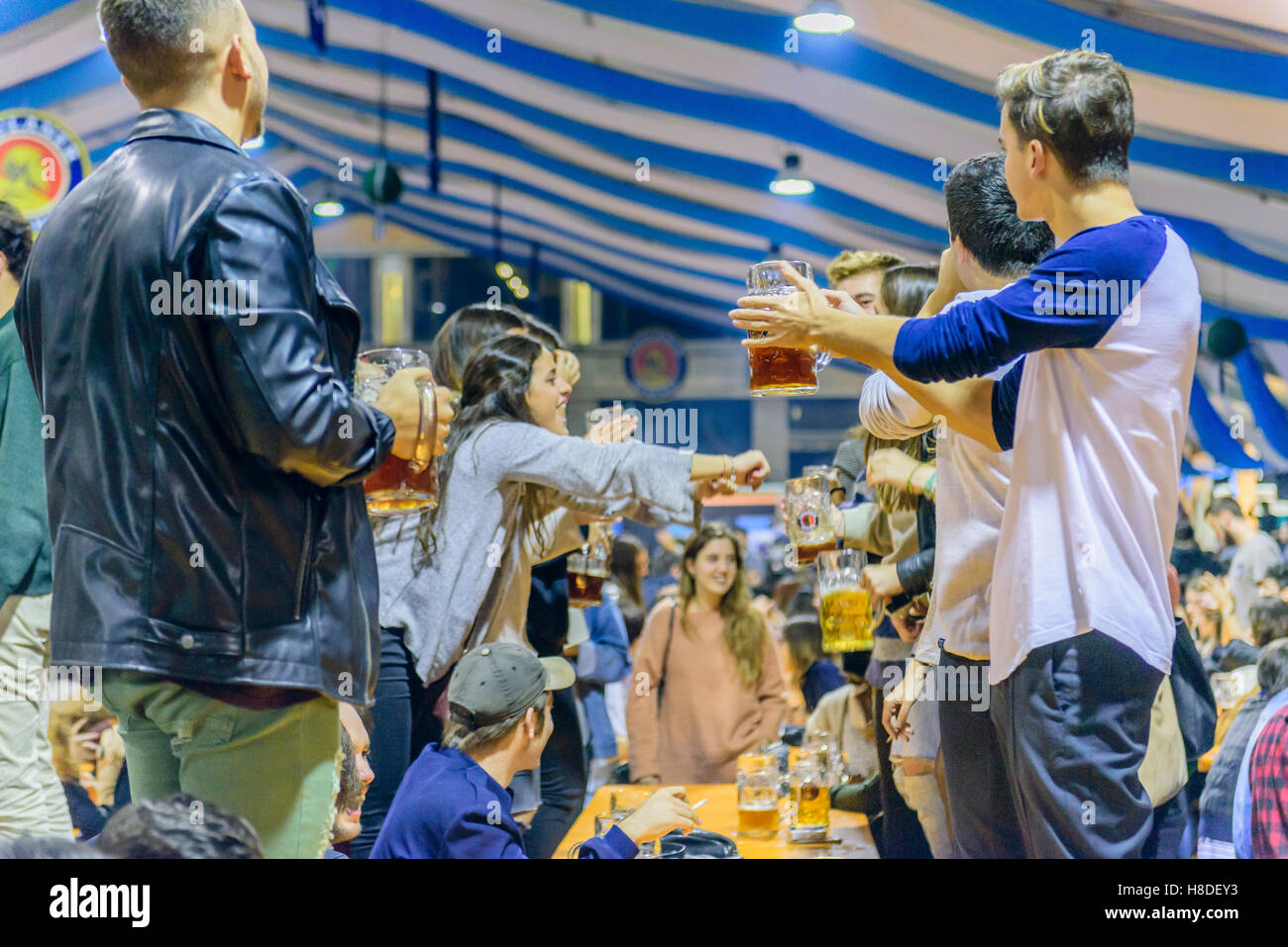 People dancing up the tables in the Oktoberfest 2016 (Barcelona, Spain ...