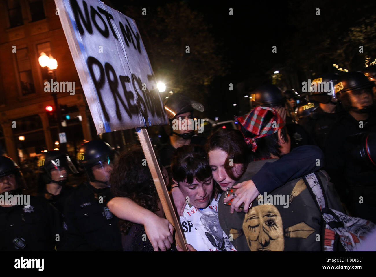 Oakland, California, USA. 9th Nov, 2016. Protestors hug each other as ...