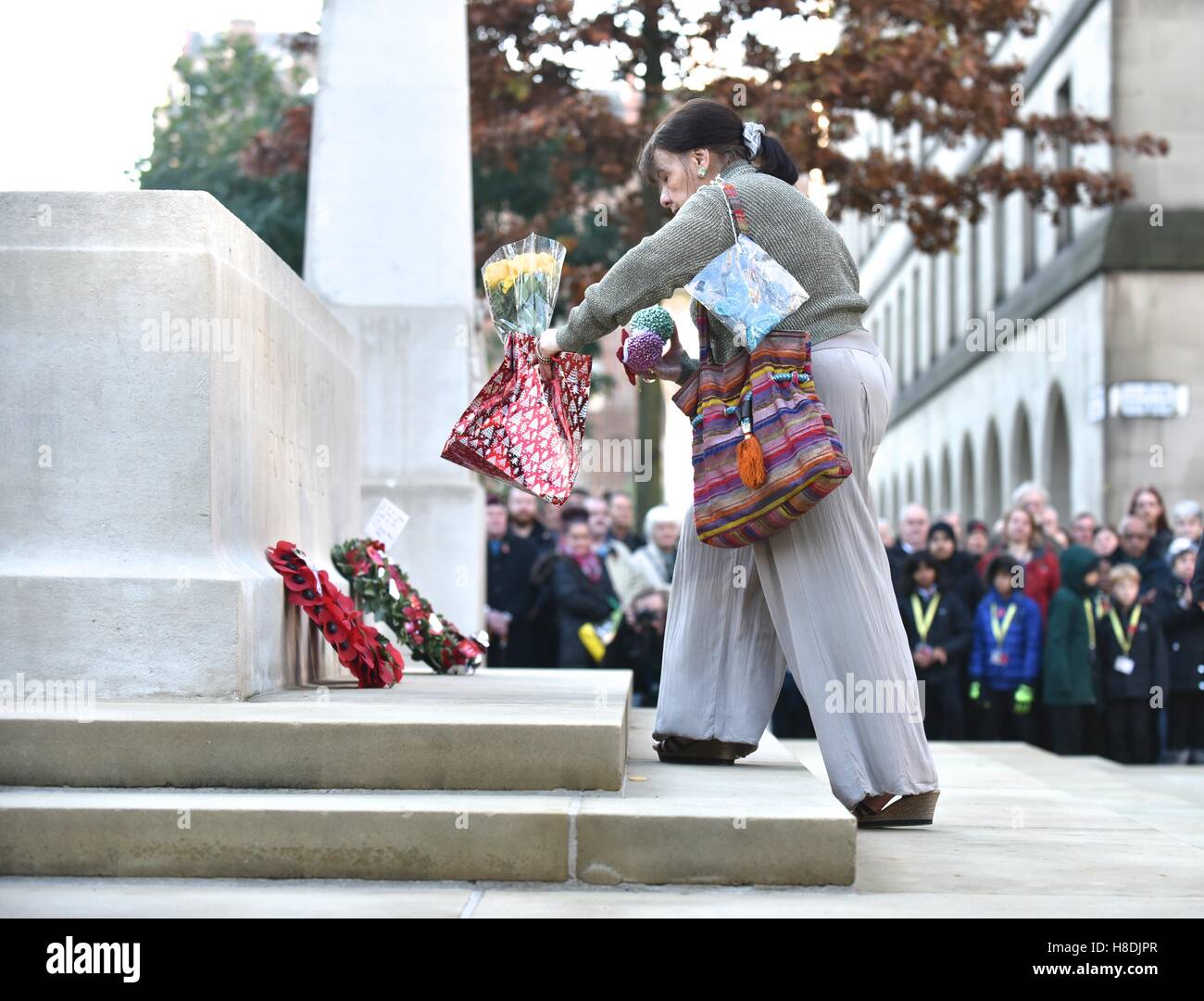 Woman laying flowers respect hi-res stock photography and images - Alamy