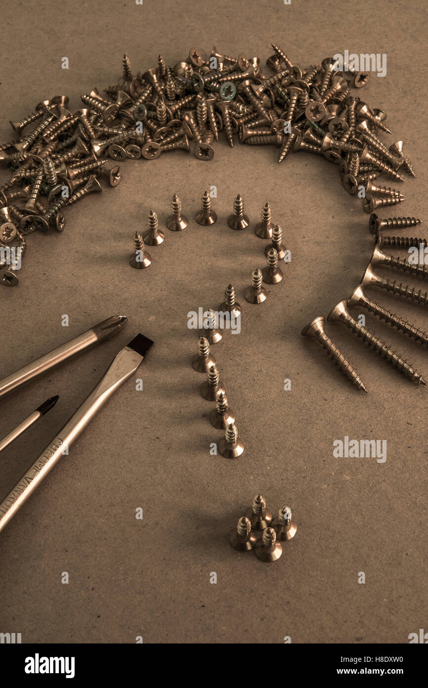 Pile and Line of Screws lin shape of Question Mark with screwdrivers ...