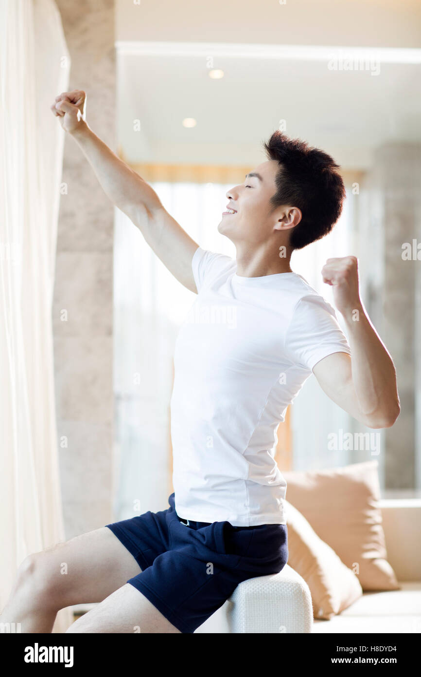 Young Chinese man stretching at home Stock Photo - Alamy