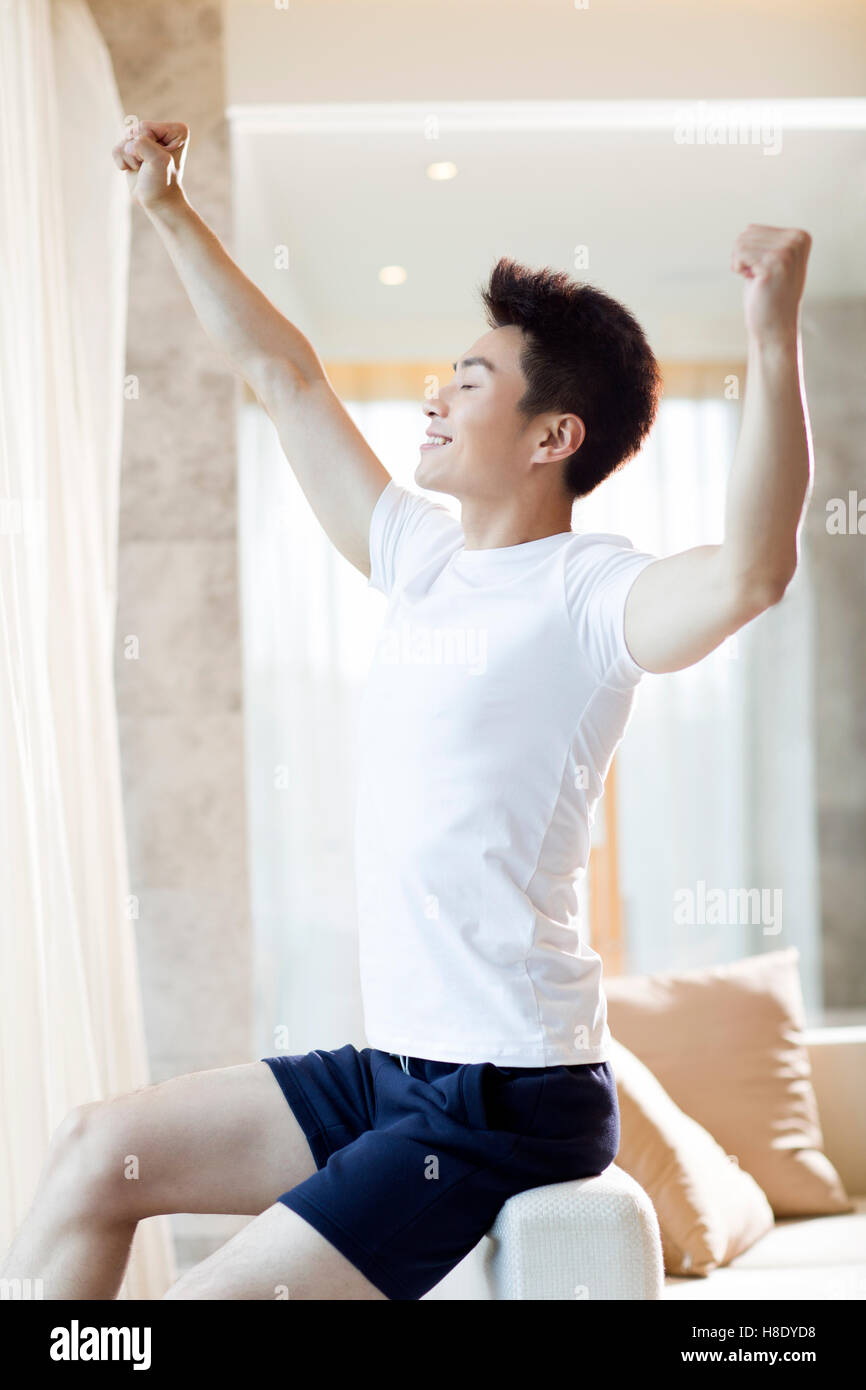 Young Chinese man stretching at home Stock Photo - Alamy