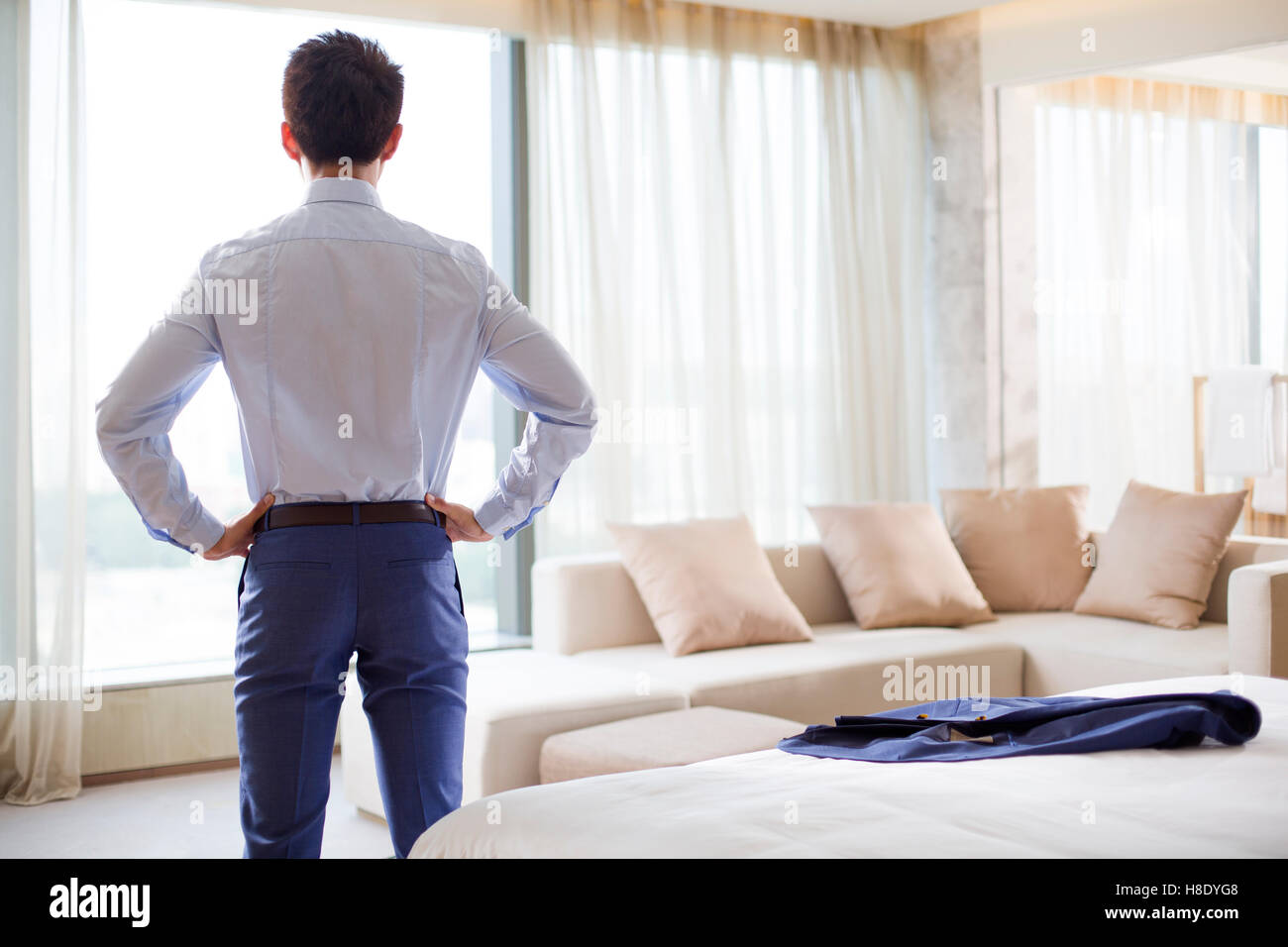 Young Chinese businessman getting dressed in the morning Stock Photo ...