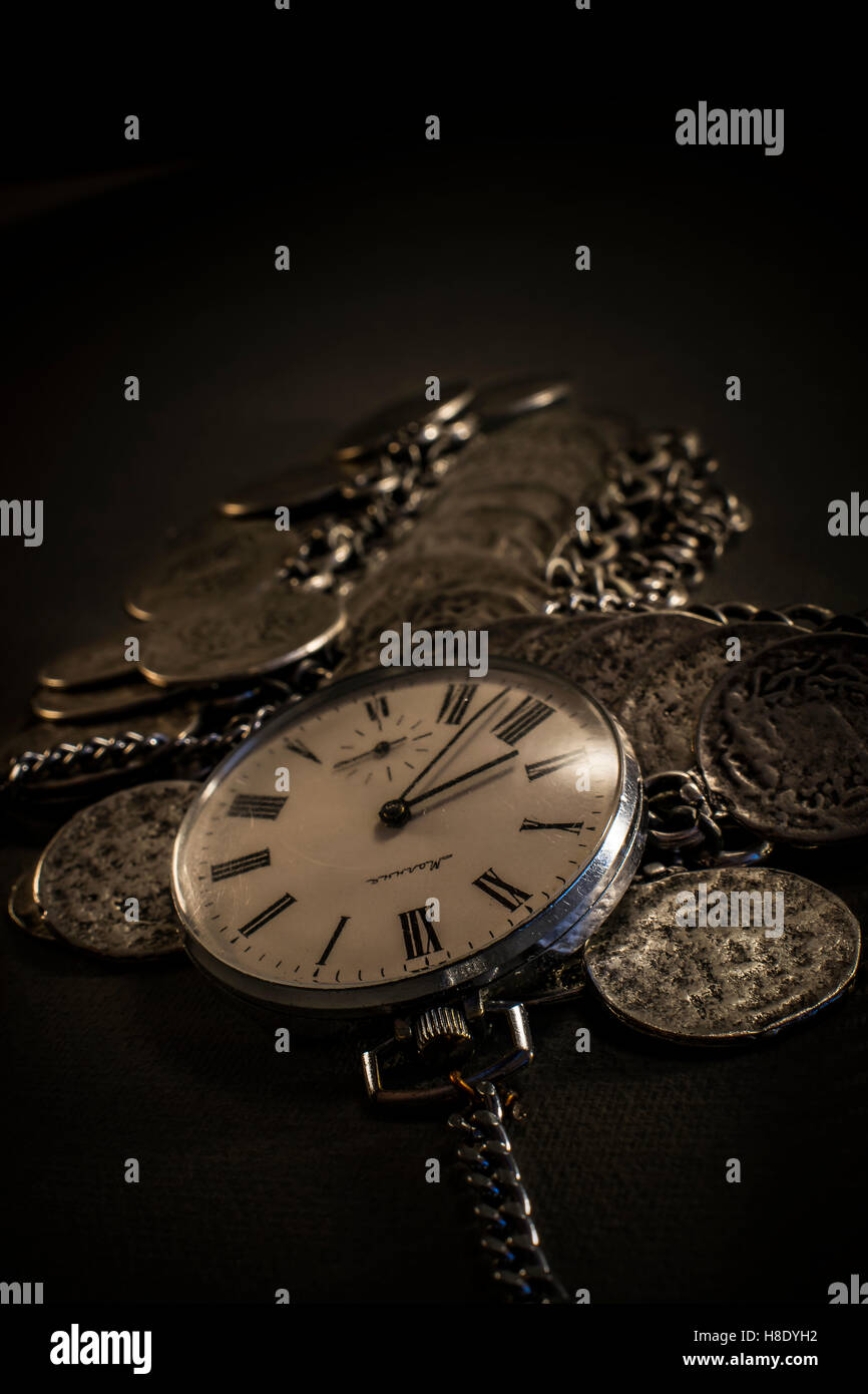 Silver pocket watch with silver coins hi-res stock photography and ...