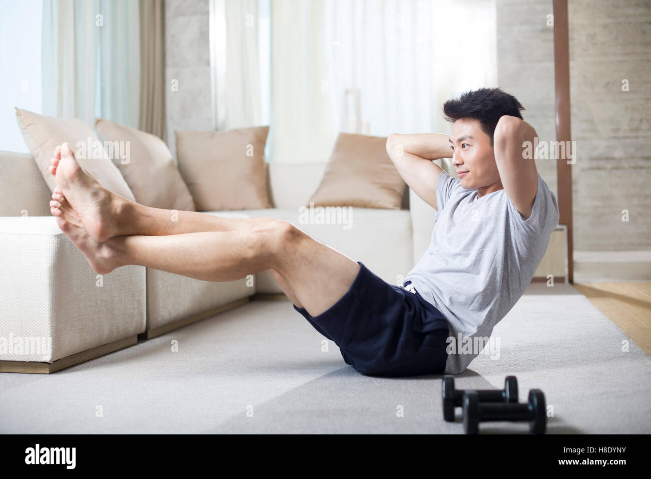 Young Chinese man exercising at home Stock Photo - Alamy