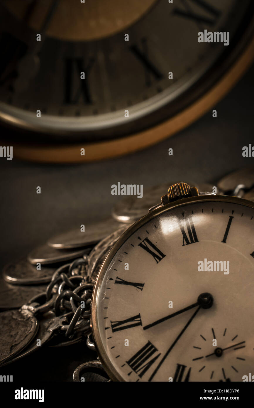 Silver pocket watch with silver coins hi-res stock photography and ...