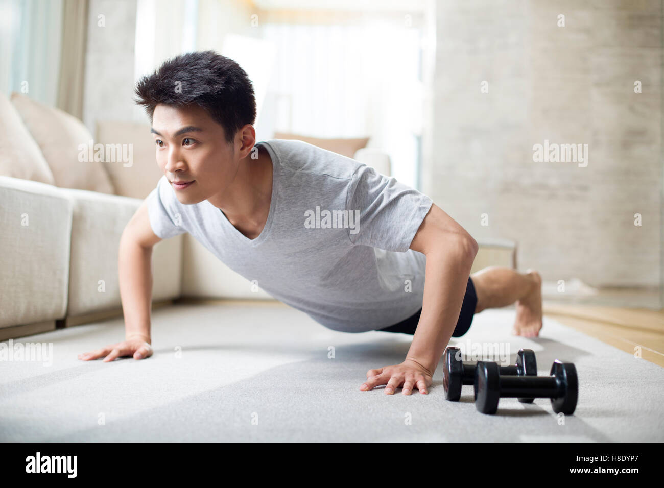Young Chinese man exercising at home Stock Photo - Alamy