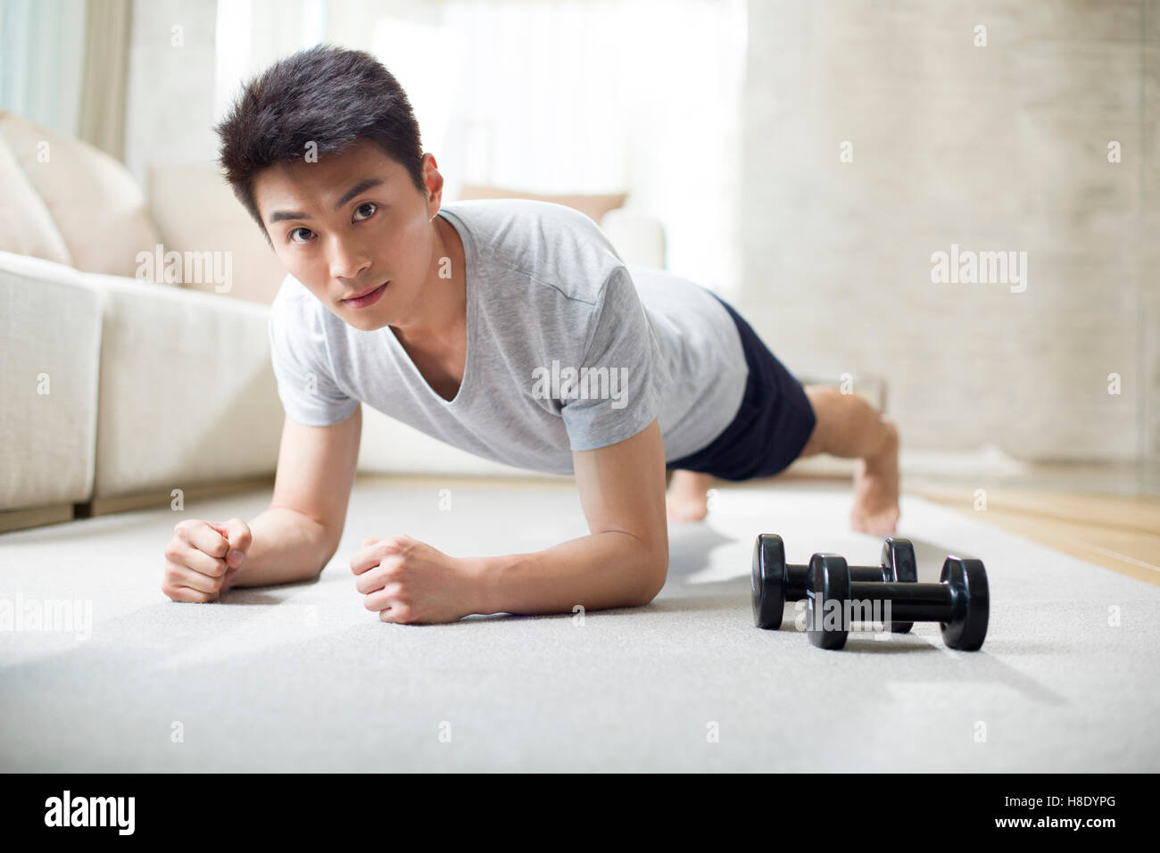 Young Chinese man exercising at home Stock Photo - Alamy