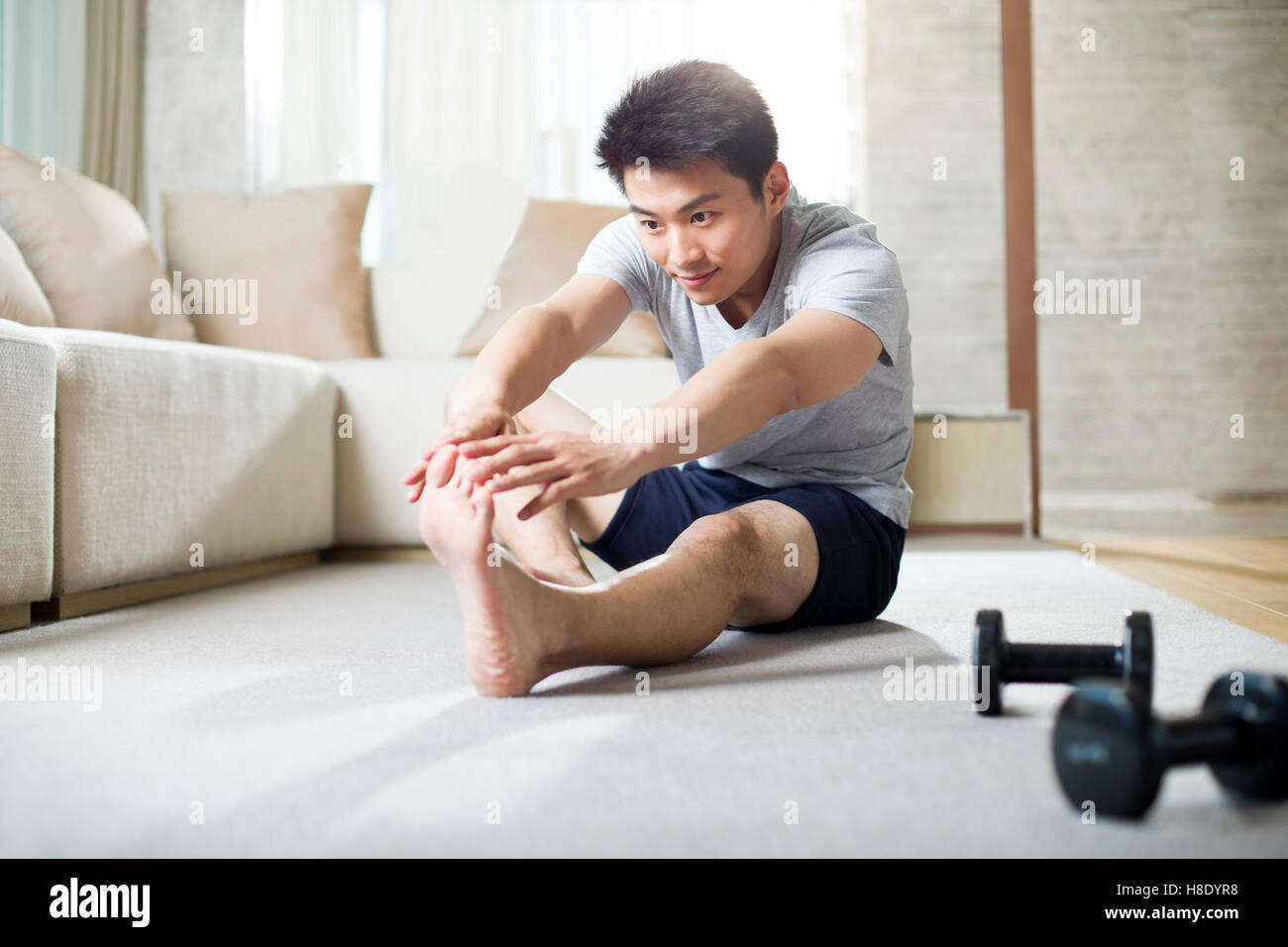 Young Chinese man exercising at home Stock Photo - Alamy