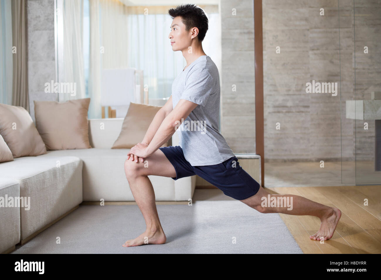 Young Chinese man exercising at home Stock Photo - Alamy