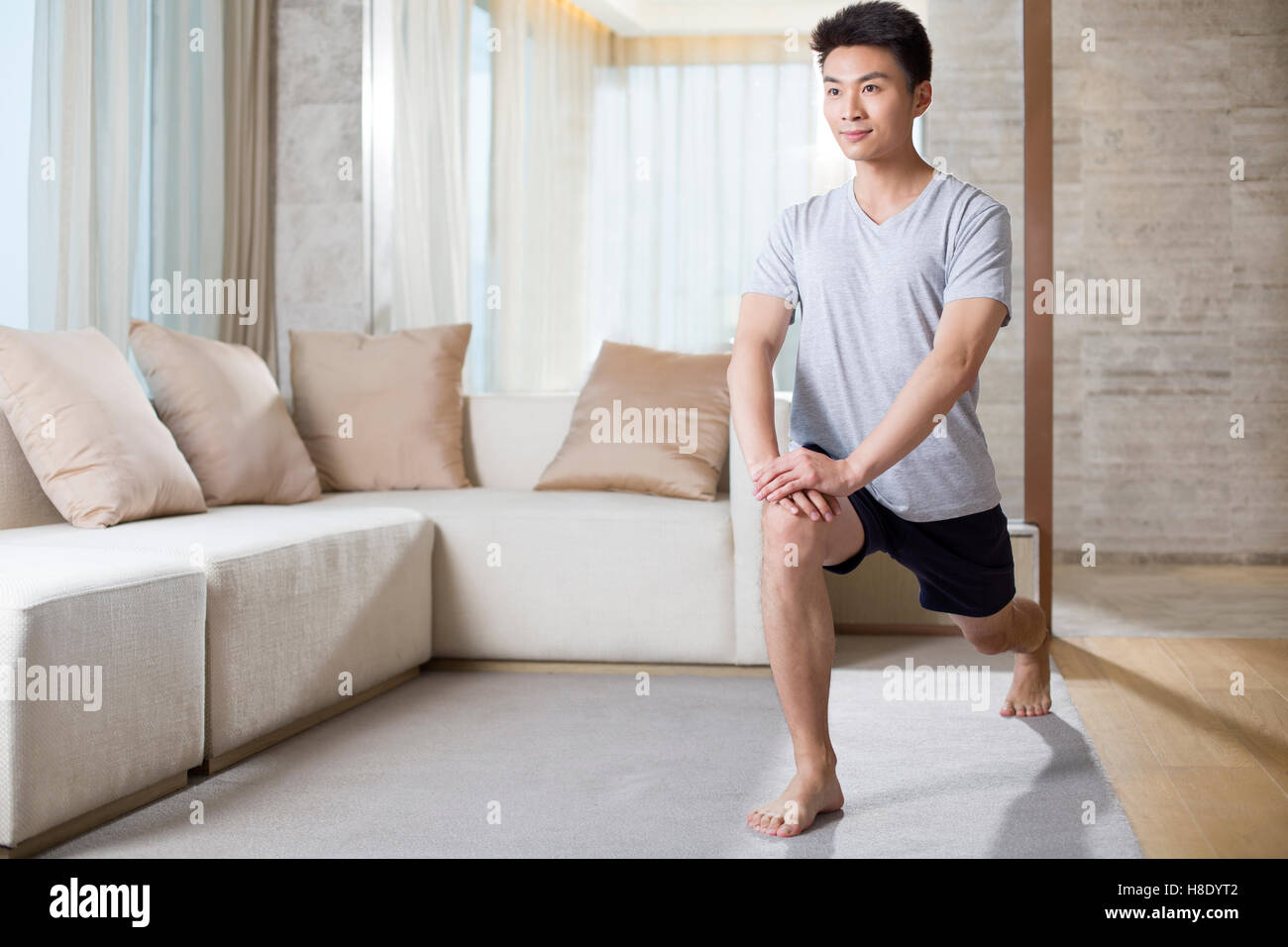 Young Chinese man exercising at home Stock Photo - Alamy