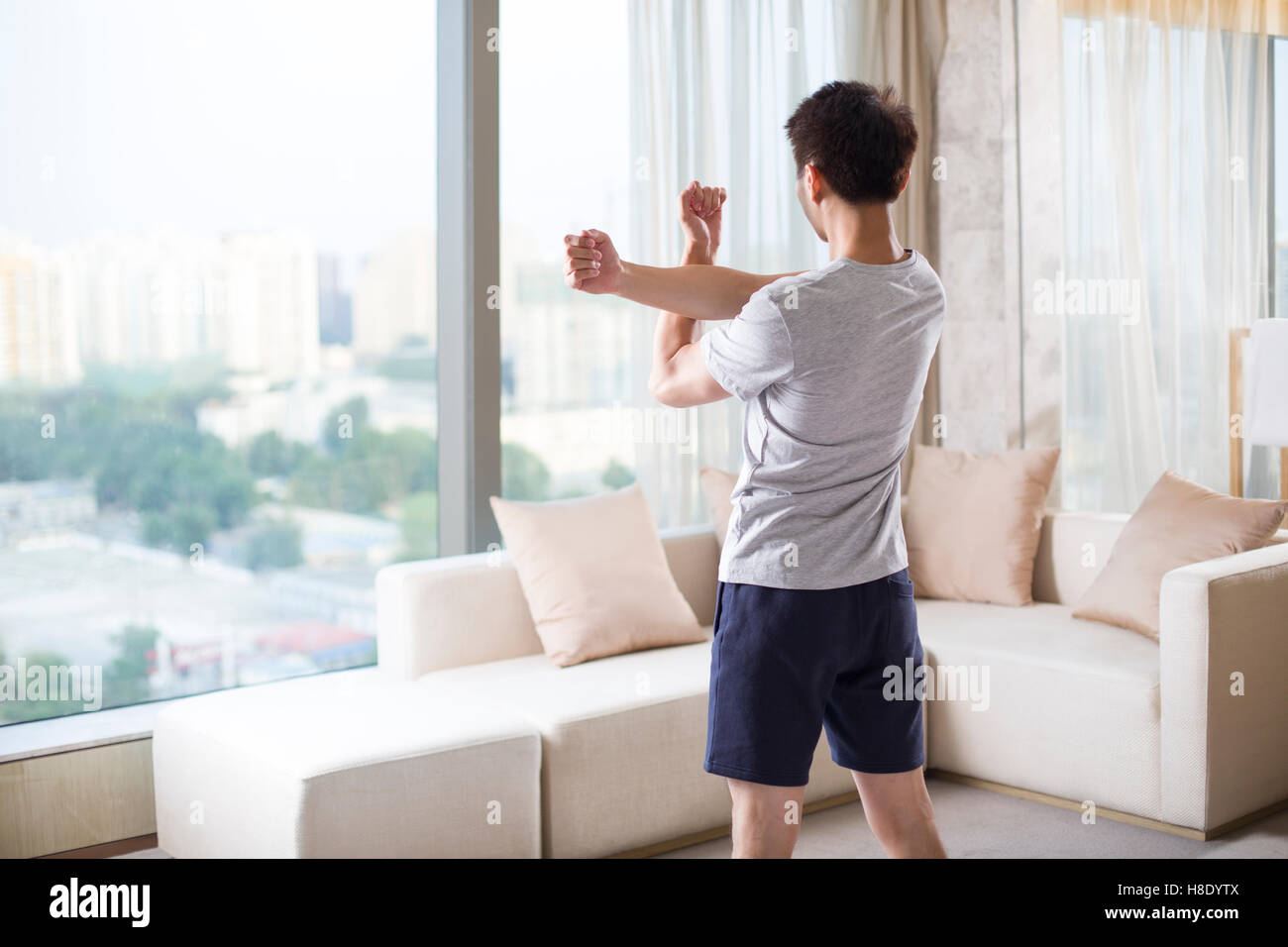 Young Chinese man exercising at home Stock Photo - Alamy