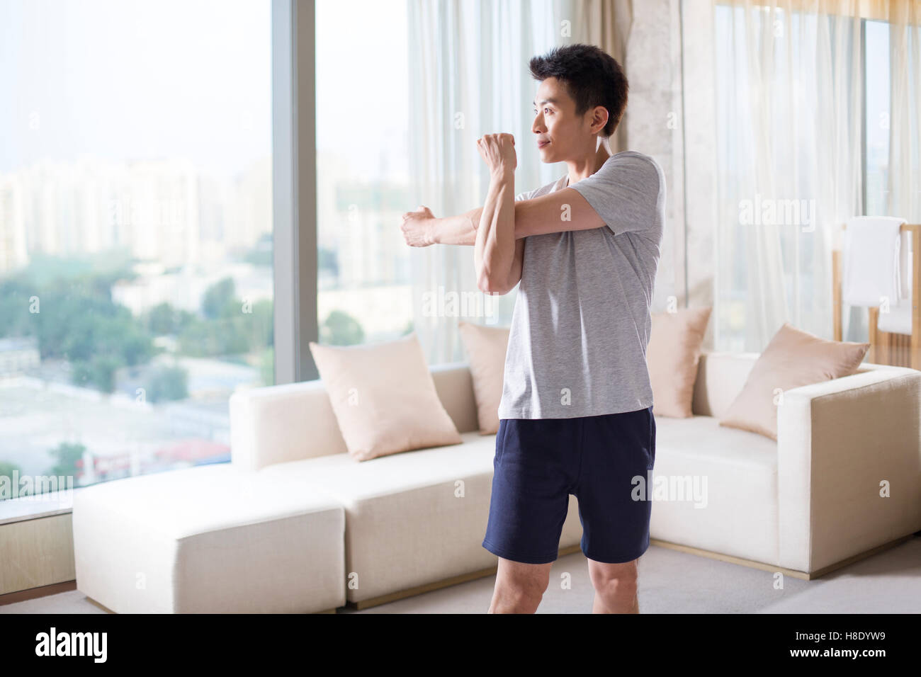 Young Chinese man exercising at home Stock Photo - Alamy