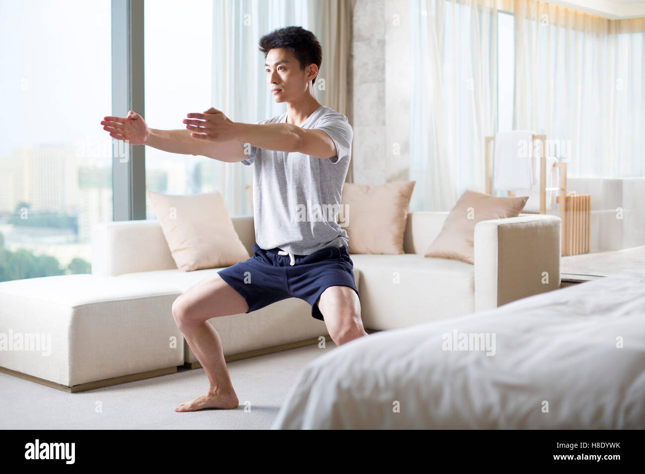 Young Chinese man exercising at home Stock Photo - Alamy