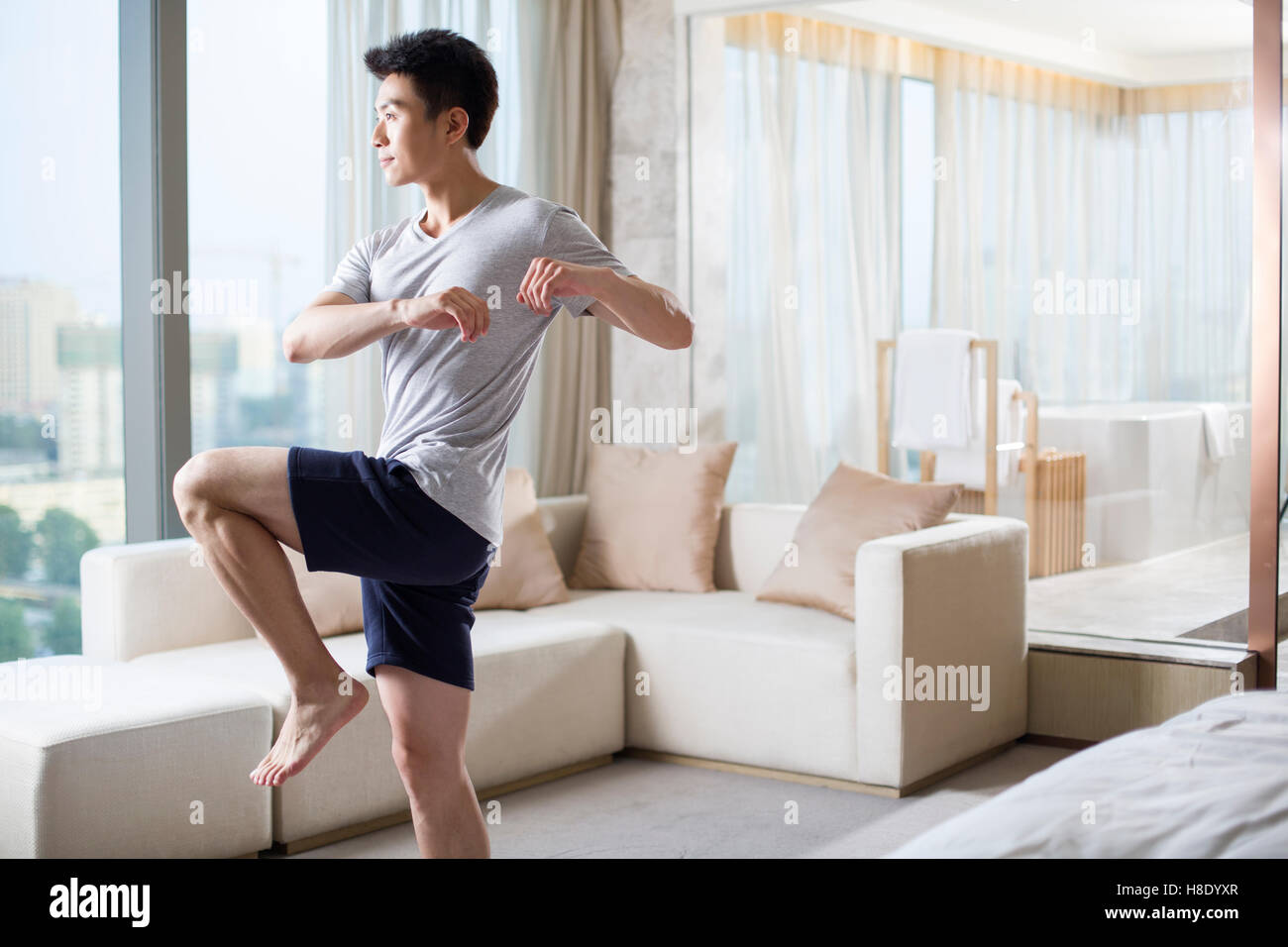 Young Chinese man exercising at home Stock Photo - Alamy