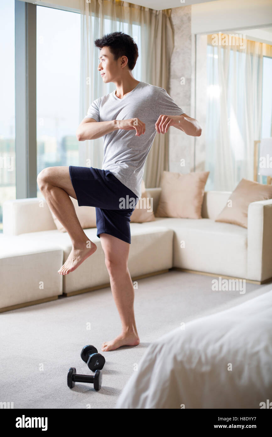 Young Chinese man exercising at home Stock Photo - Alamy