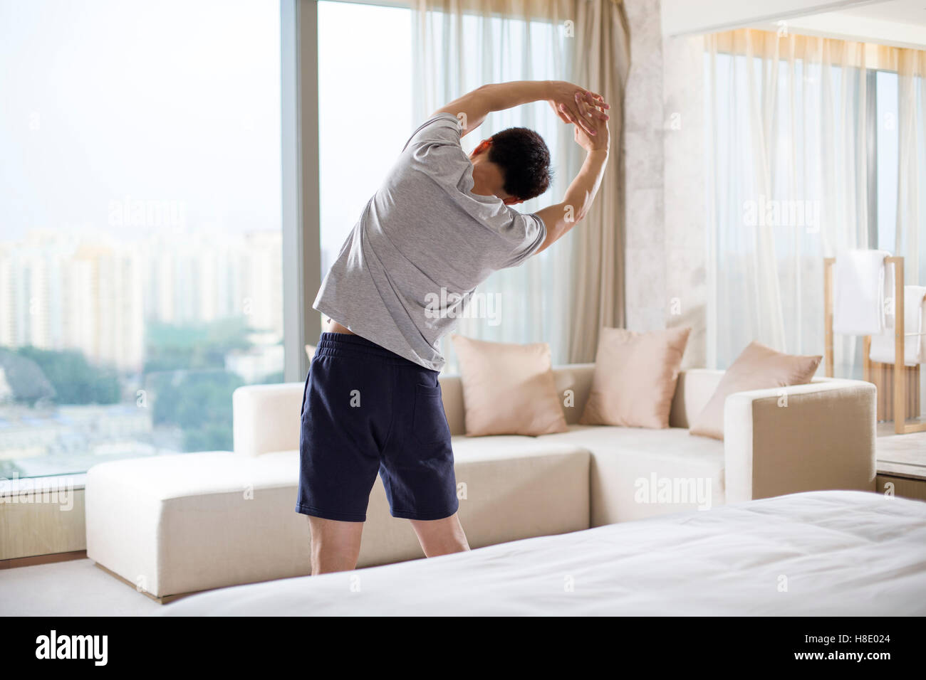 Young Chinese man exercising at home Stock Photo - Alamy