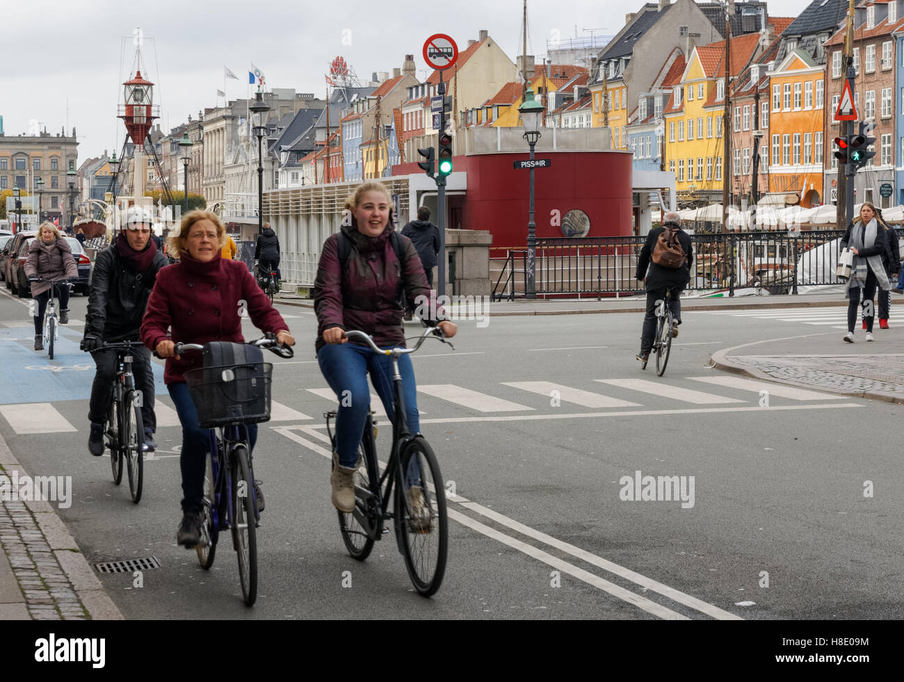 Cyclists riding along Nyhavn canal in Copenhagen, Denmark Stock Photo ...