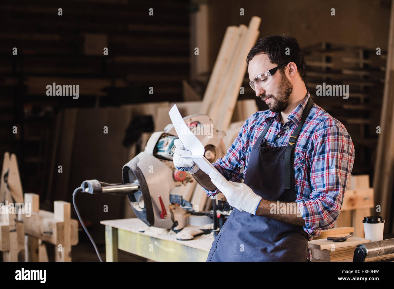 profession, carpentry, woodwork people concept - carpenter with wood ...