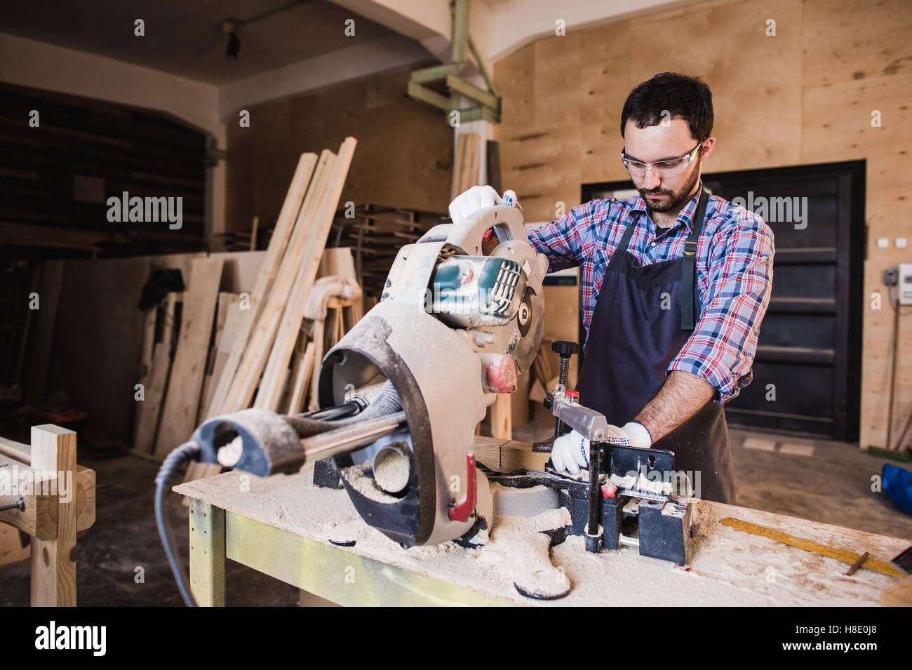 Carpenter Using Circular Saw for wood at his workshop Stock Photo - Alamy