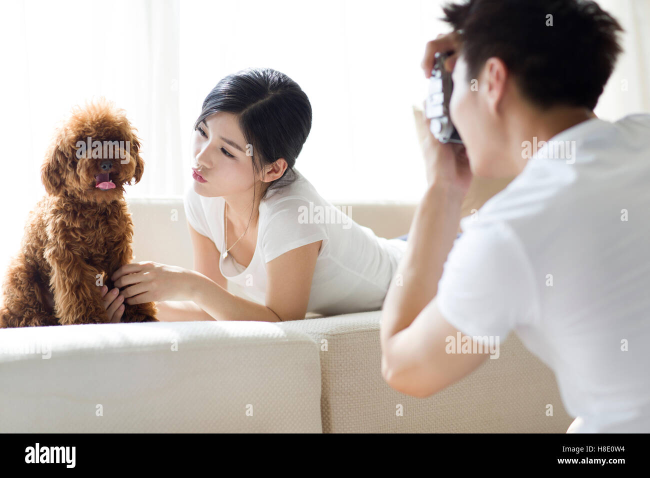 Young Chinese couple taking photos at home Stock Photo - Alamy