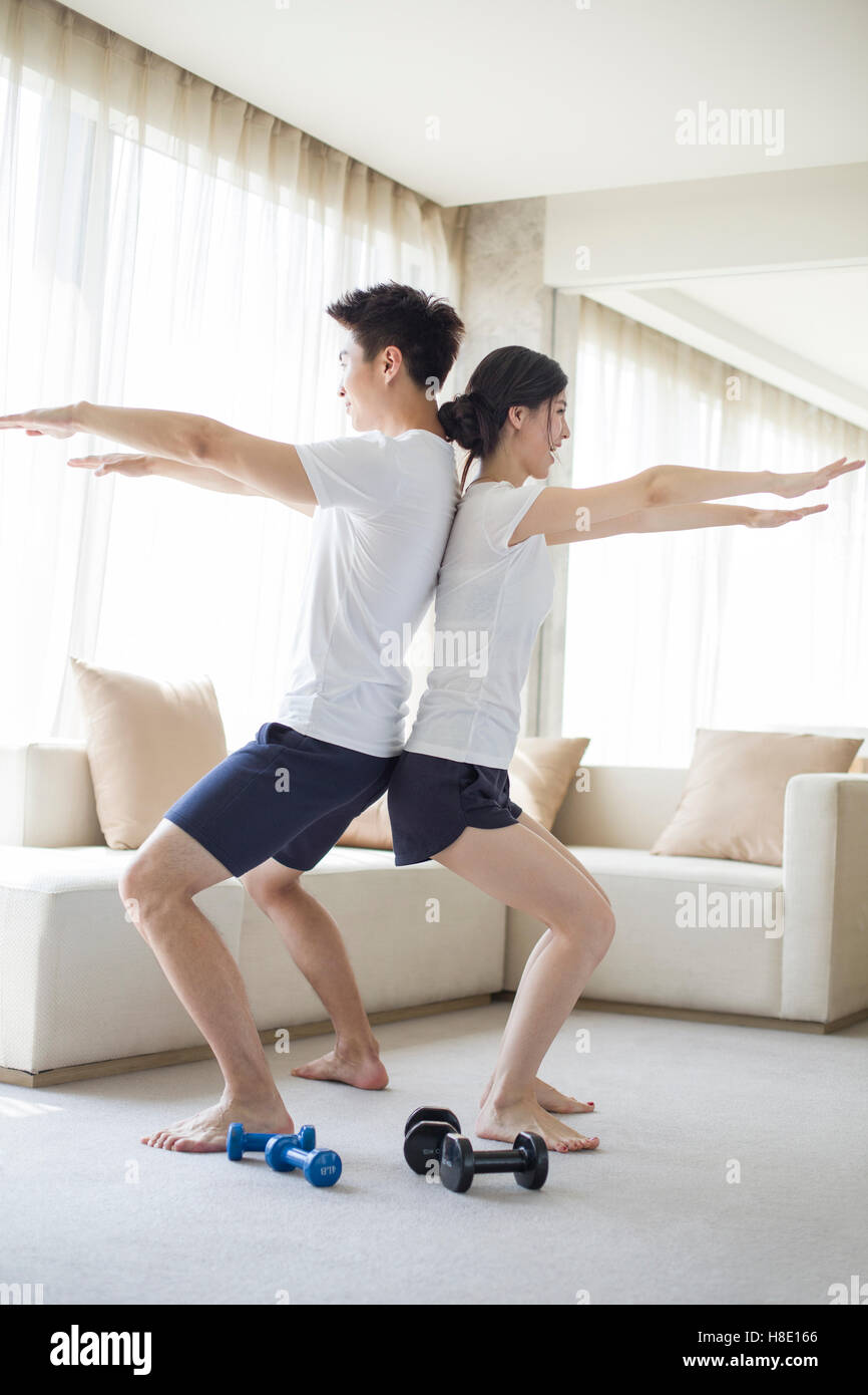 Young Chinese couple exercising at home Stock Photo - Alamy