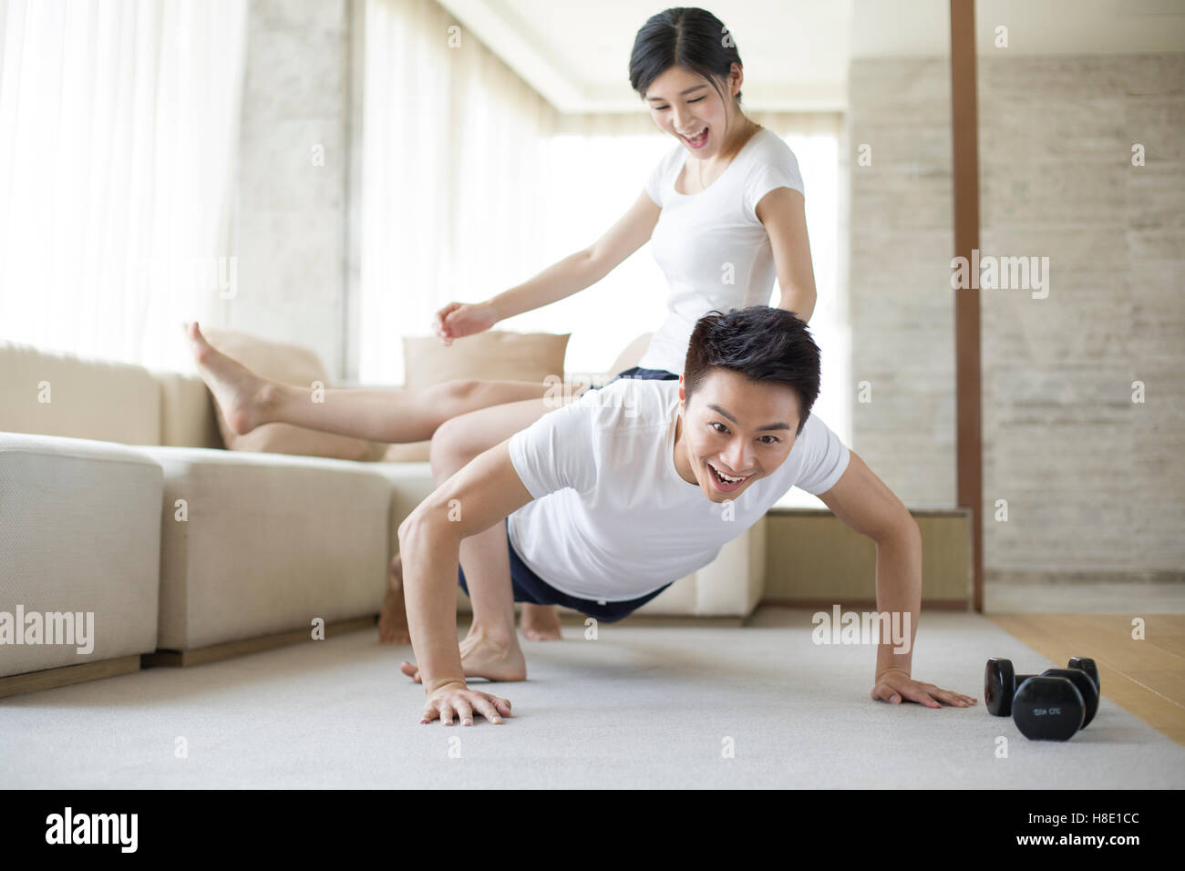 Young Chinese couple exercising at home Stock Photo - Alamy